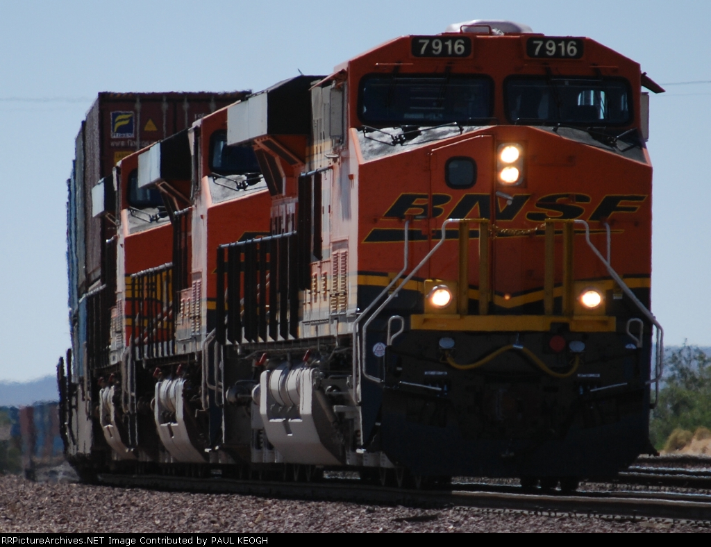 Zoom in shot of BNSF 7916 as she slows down to enter the BNSF Barstow yard pulling a eastbound Z.